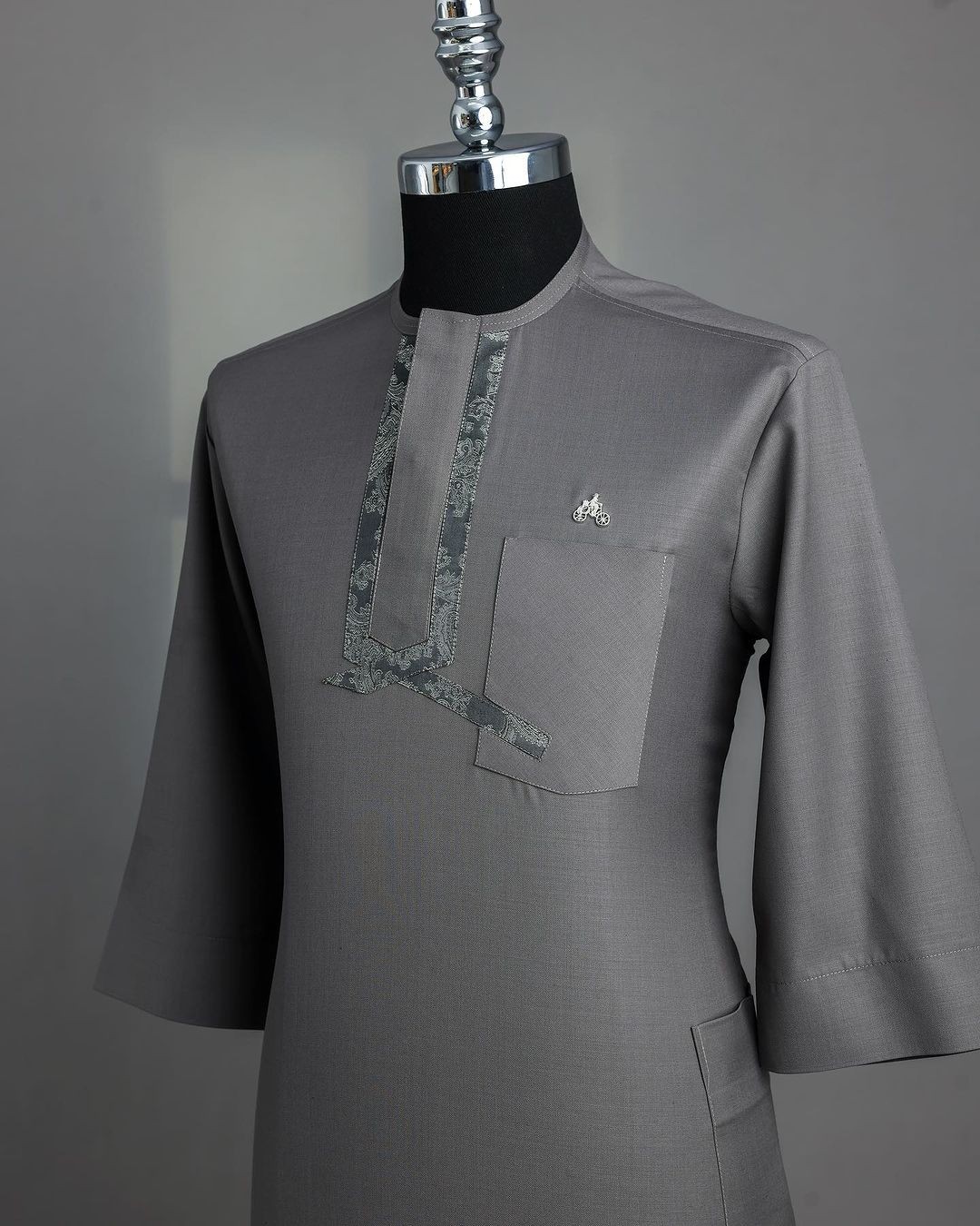 A grey, matching slanted paisley, front flap, 3/4-sleeve African senato ...