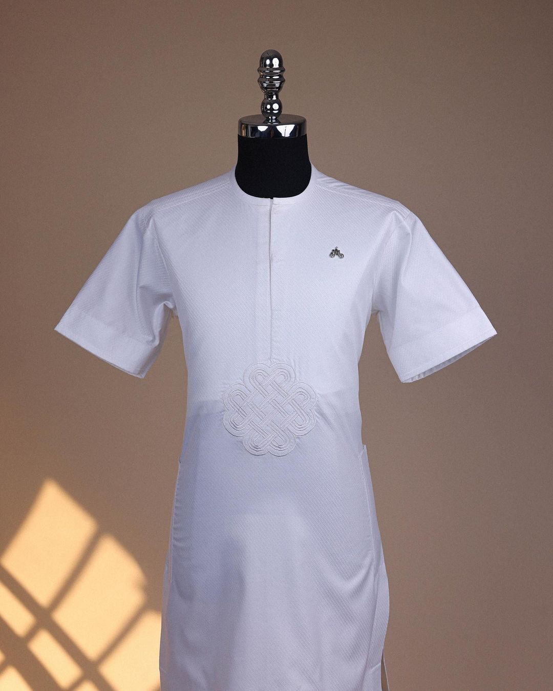A bright white, zip line with embrodery details, short sleeve African s ...